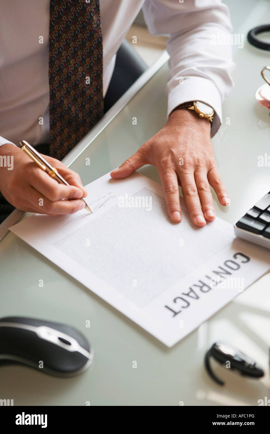 Business man signing contract, close-up Stock Photo - Alamy