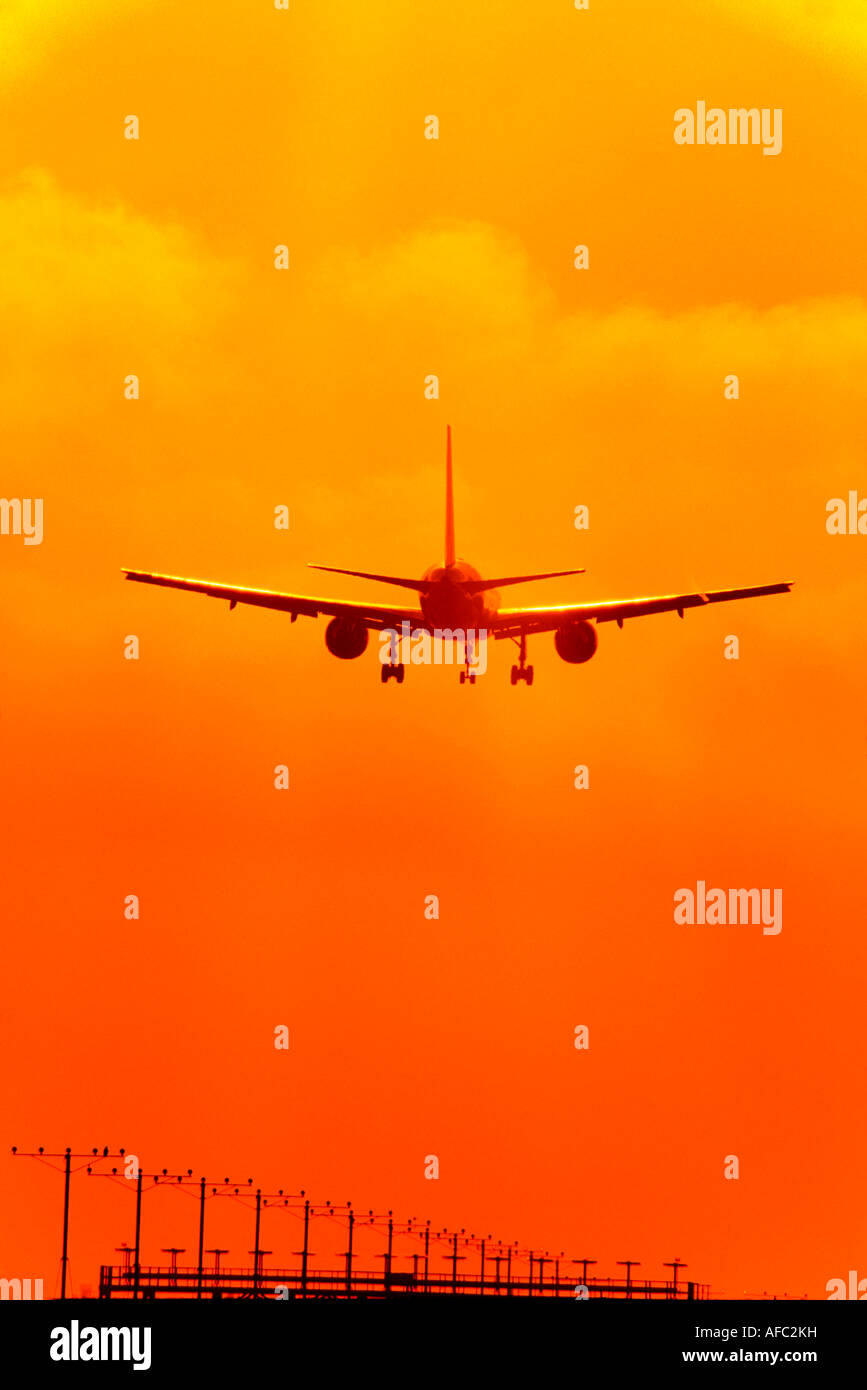 Commercial Airliner landing at Sunset Stock Photo - Alamy