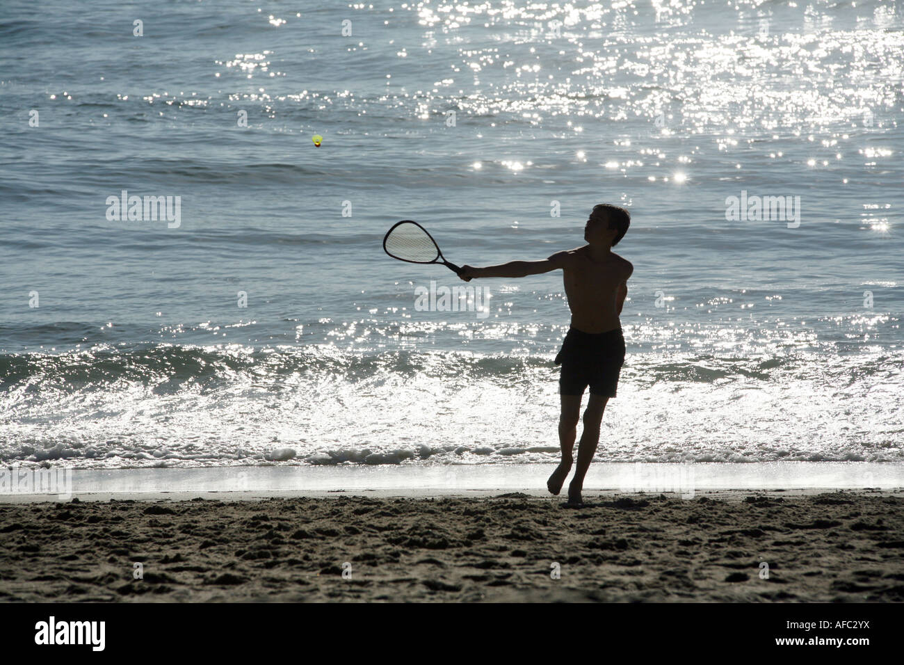 A boy playing beach games against a background of the ocean, Afife ...
