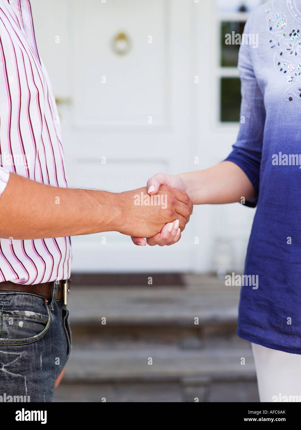 Man and woman shaking hands Stock Photo - Alamy