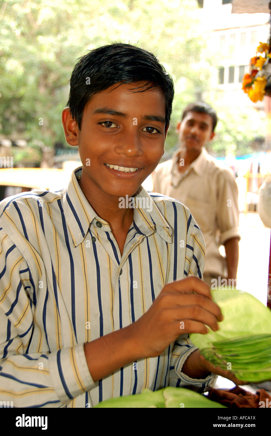 Smiling Indian boy working at a street stall in Mumbai, India Stock ...