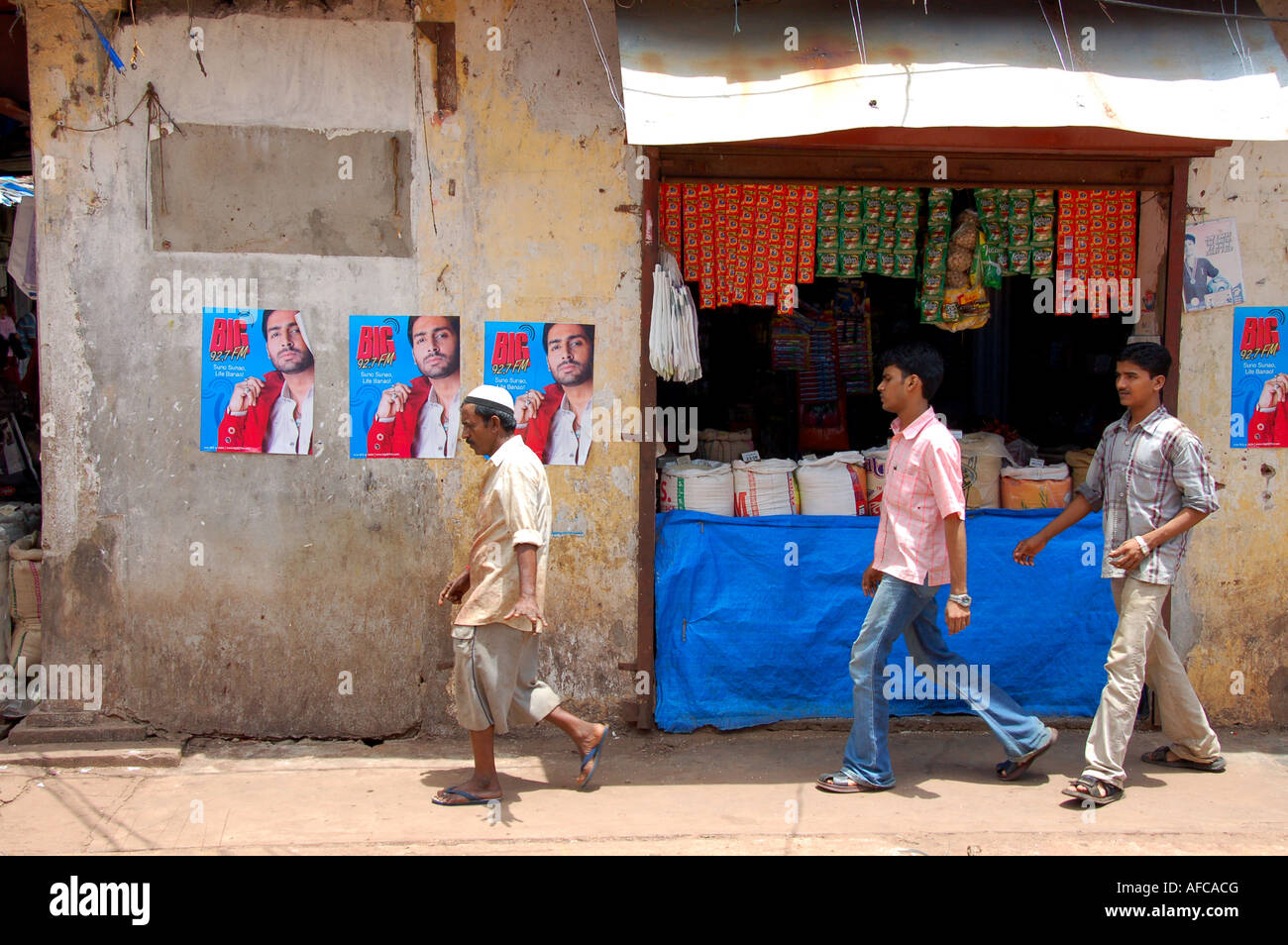 Indian men walking past a shop in Panaji, Goa, India Stock Photo - Alamy