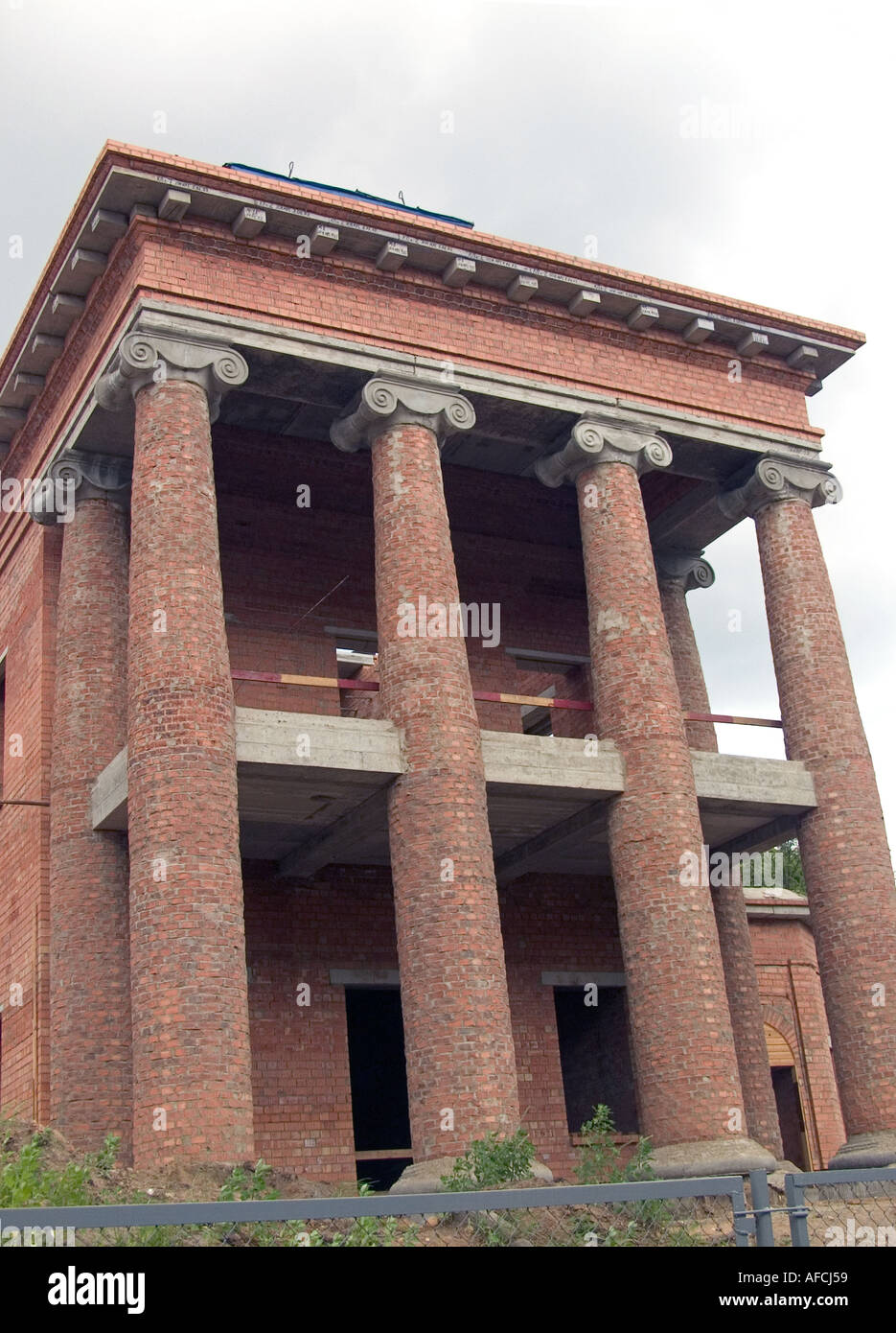 Brickwork and brick corinthian columns and capitals on a building under ...