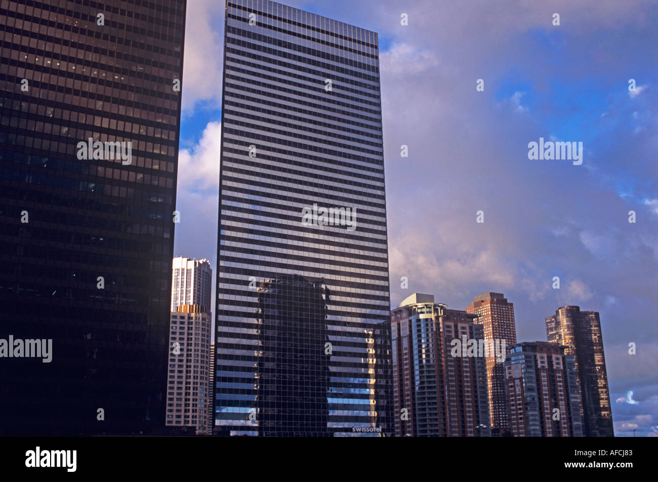 A gleaming skyscraper, the Swissôtel's glass-walled triangular building ...