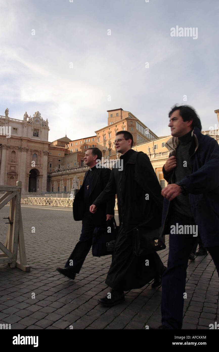 Three young priests walk across St Peter's Square in the Vatican City ...