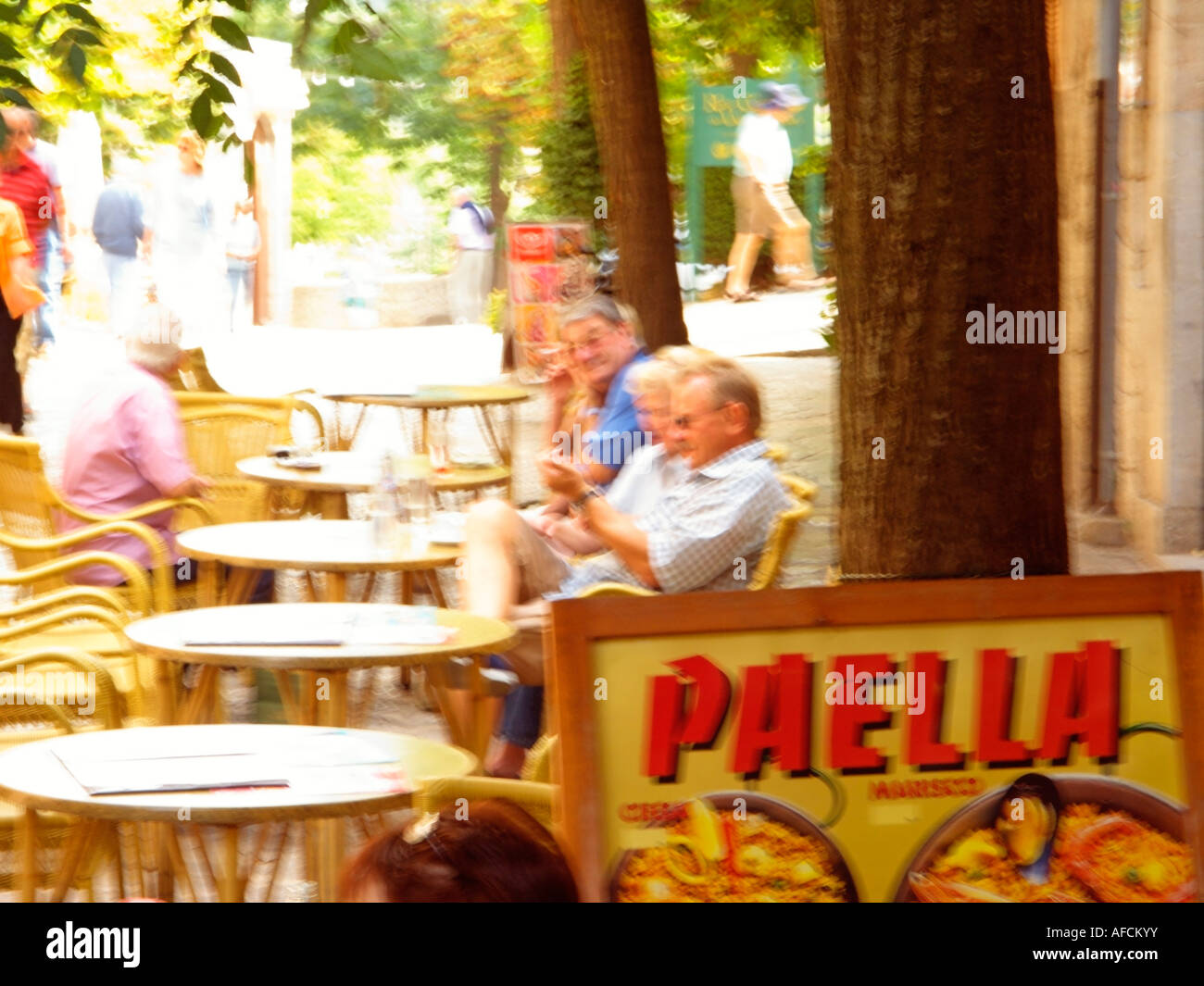 Paella sign, Street Café and Restaurant, tourists relaxing and eating ...