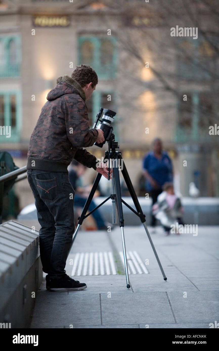 A young man filming a documentary Stock Photo - Alamy