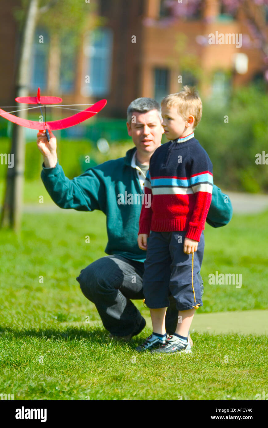 father teaching son how to throw a model airplane Stock Photo - Alamy
