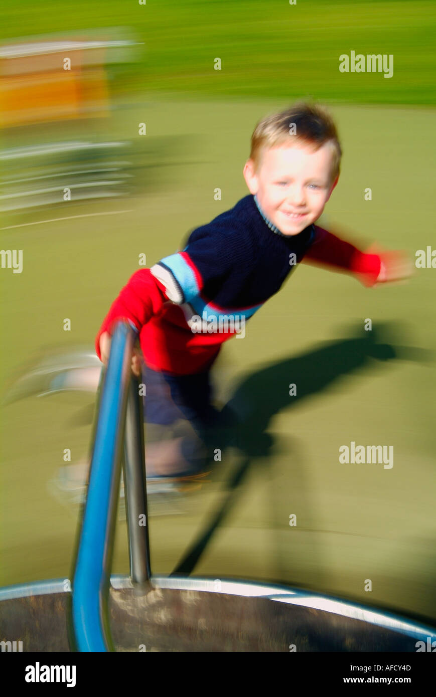Child merry go round pushing hi-res stock photography and images - Alamy