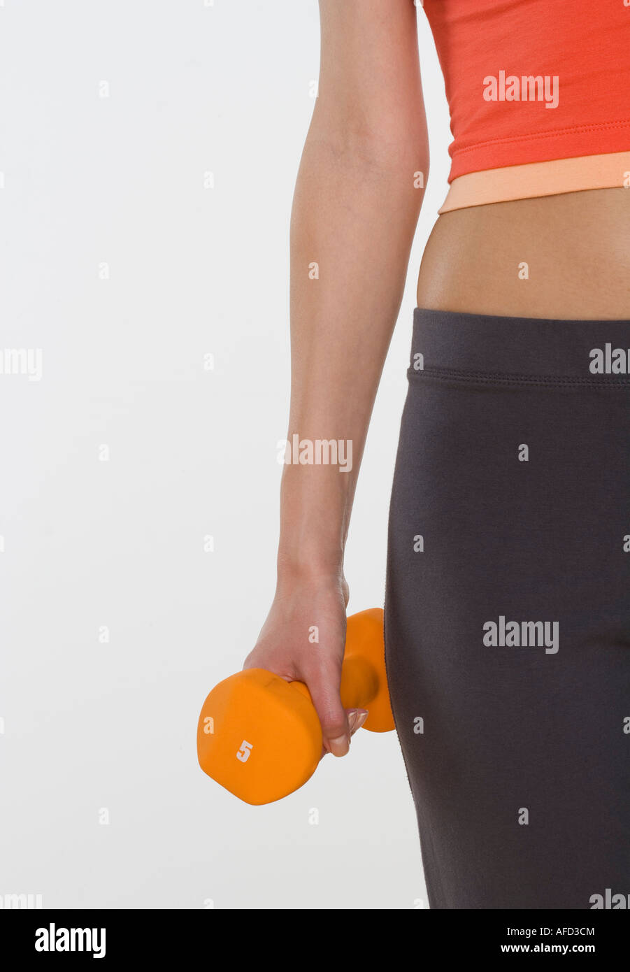 Young woman holding a hand weight Stock Photo - Alamy
