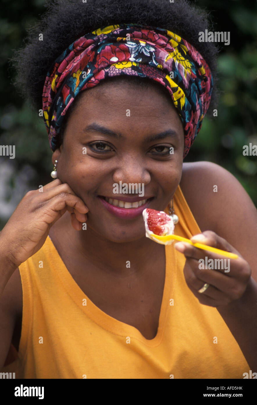ethnic woman eating strawberries with cream Stock Photo - Alamy