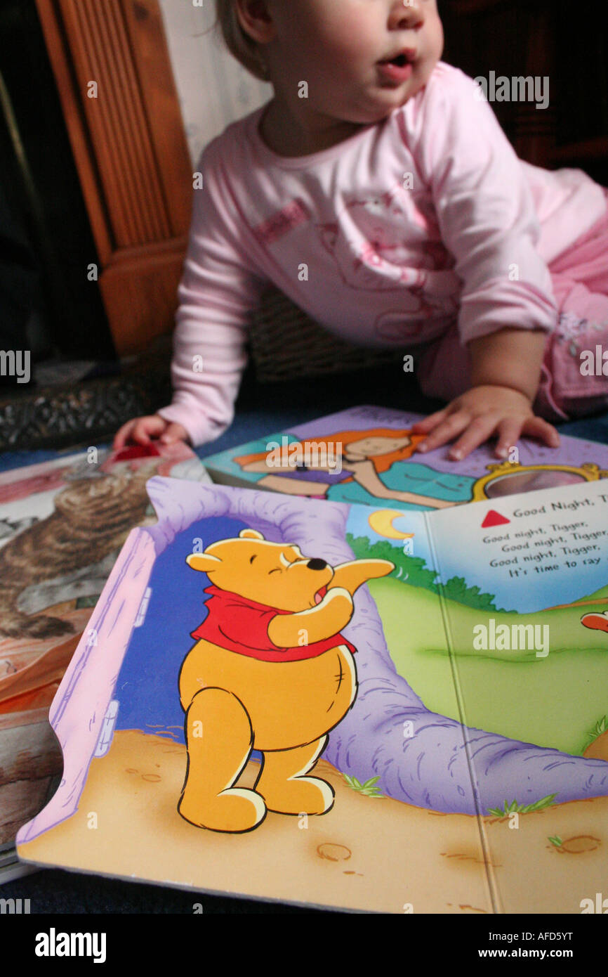 Young Child Reading Whinne the Pooh Book Stock Photo - Alamy