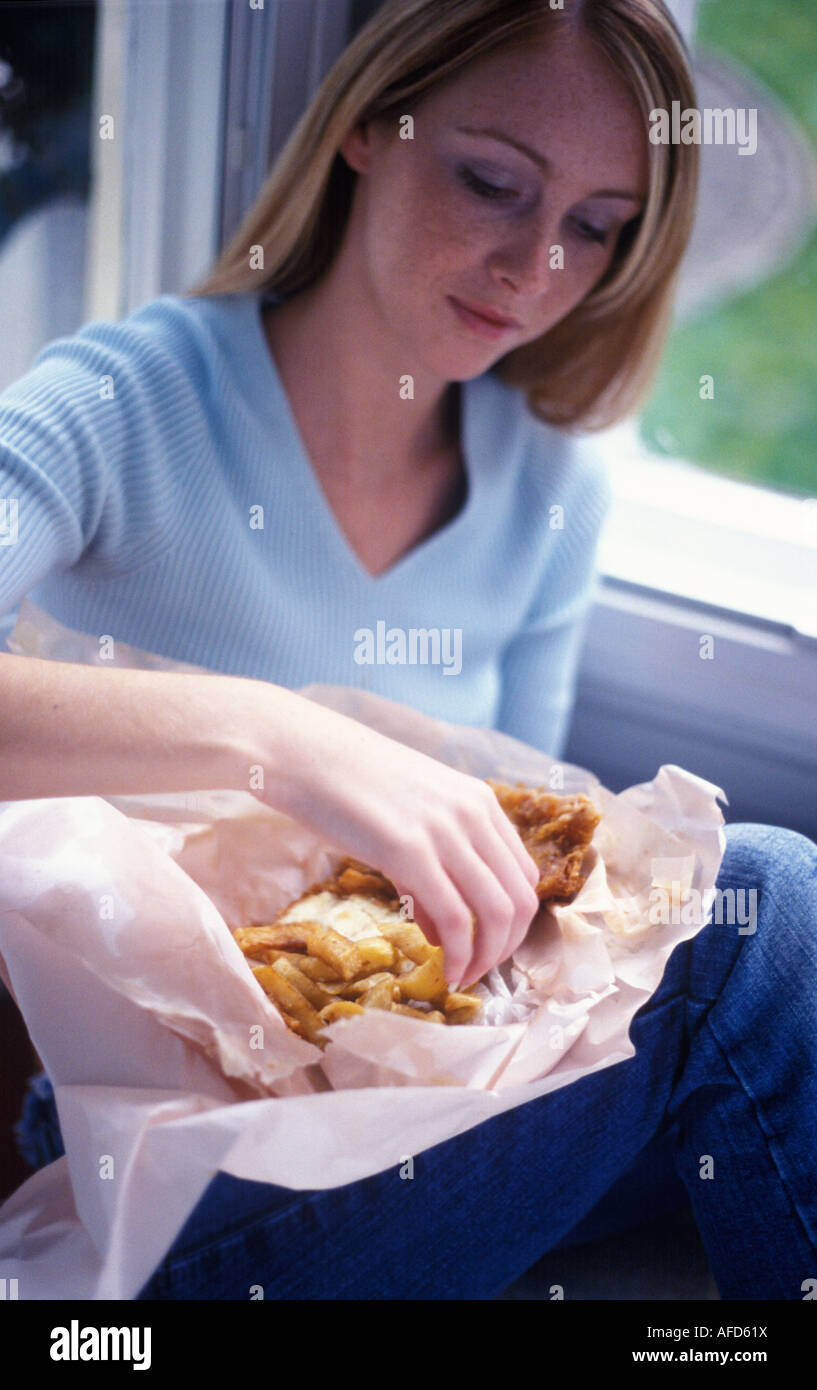 Woman eating Fish and Chips Stock Photo - Alamy