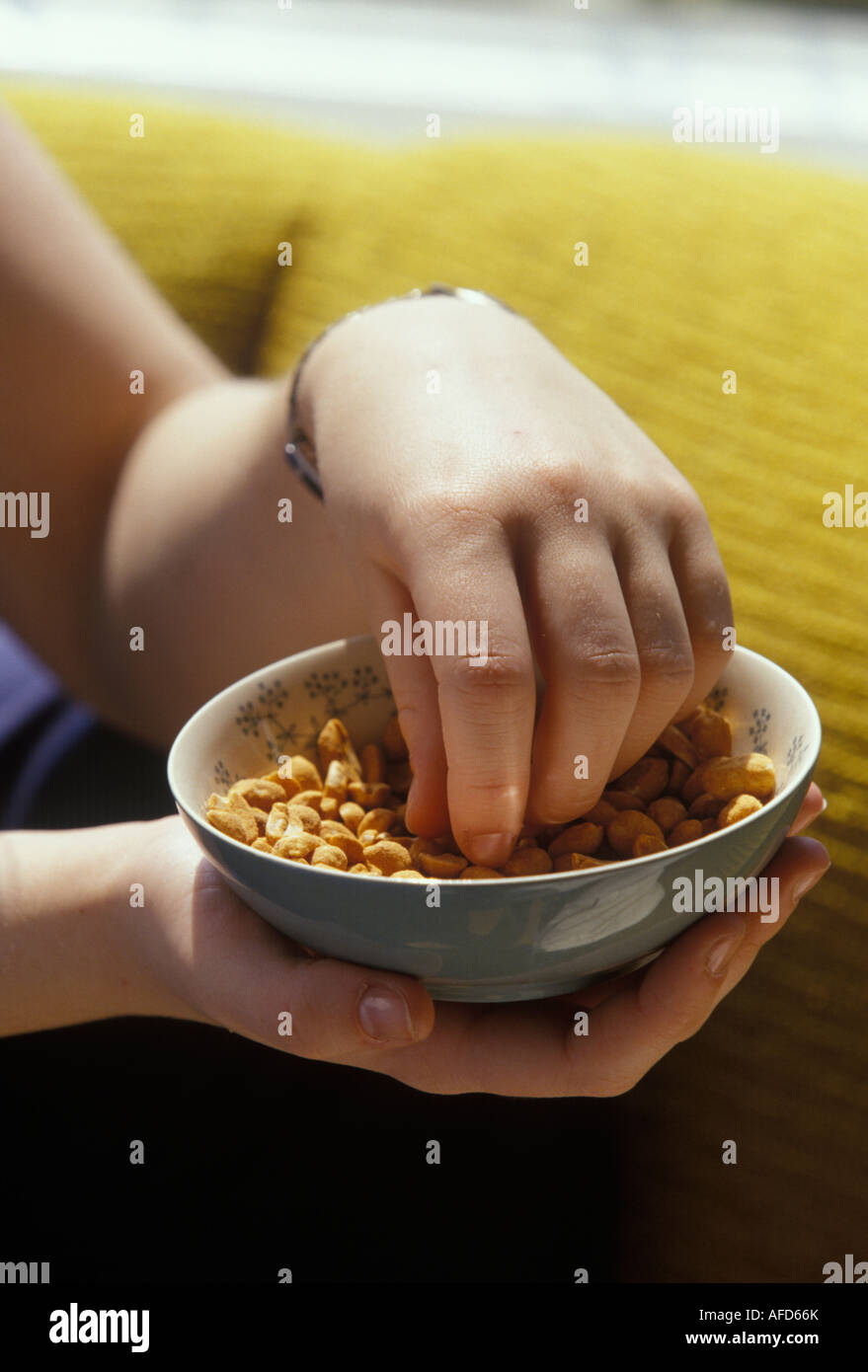 detail of woman s fingers in a bowl of nuts Stock Photo - Alamy