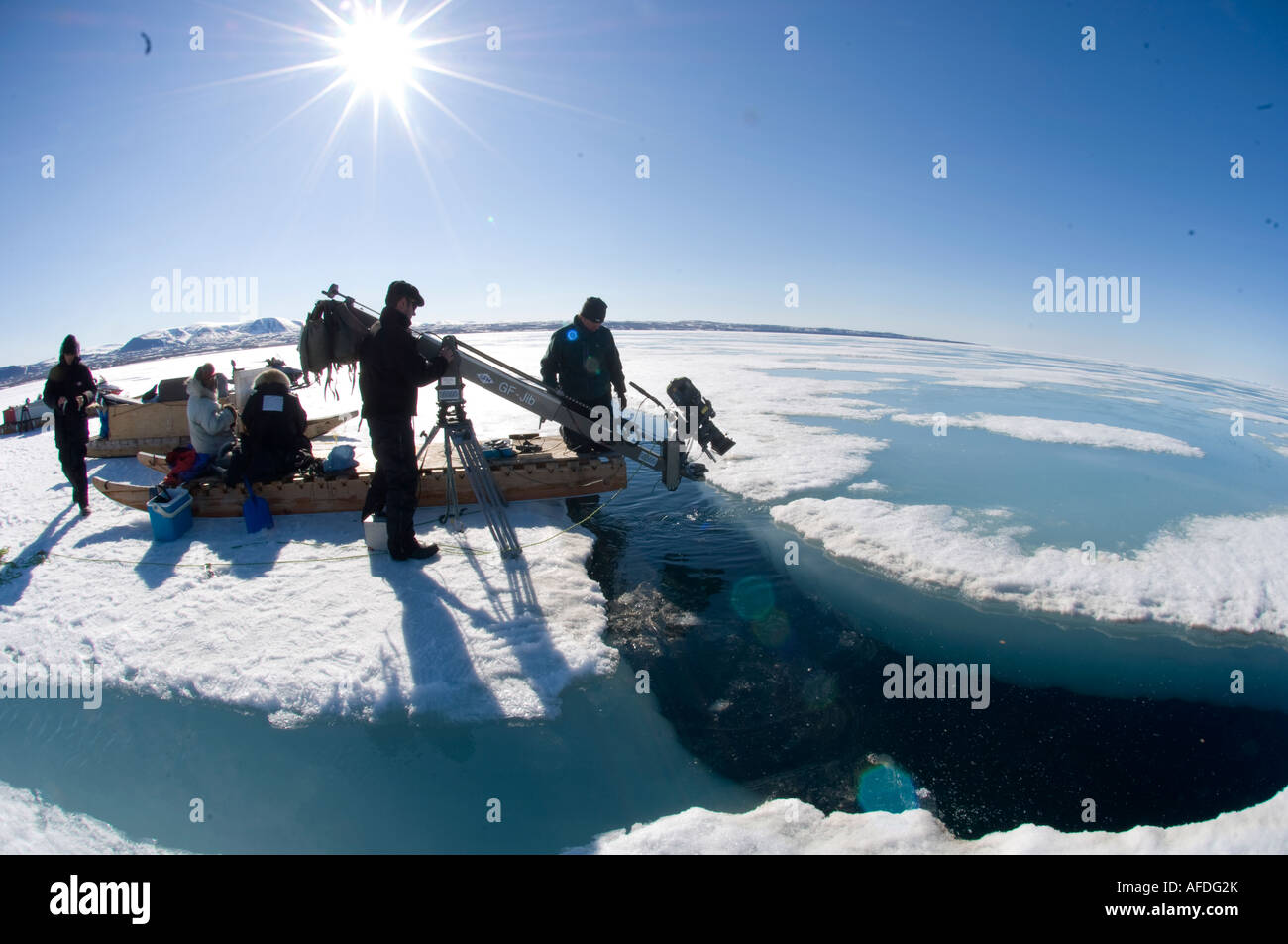 Film crew working in high arctic spring with 35mm Aaton camera using ...