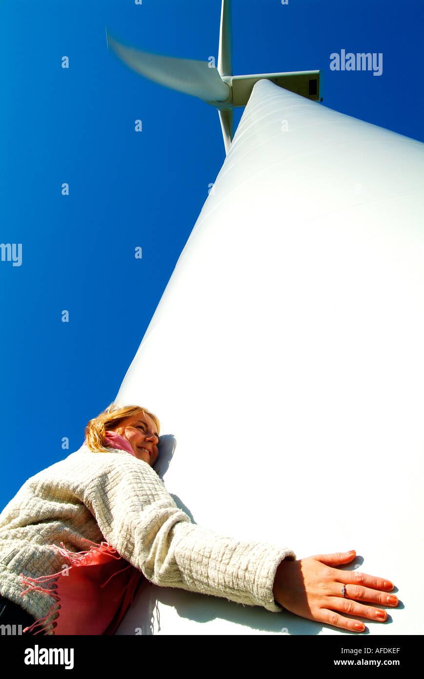 young woman hugging windfarm windmill Stock Photo - Alamy