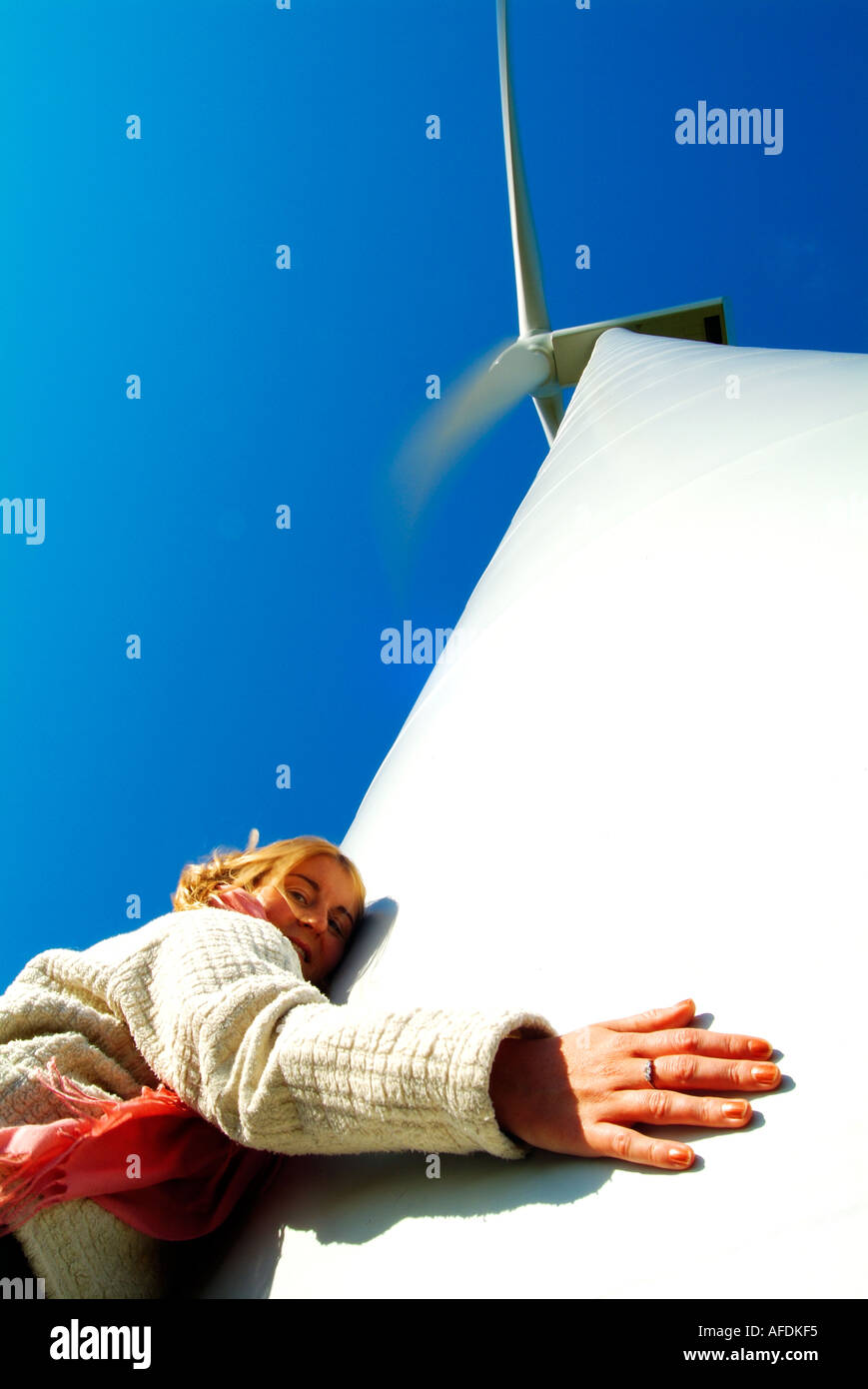 young woman hugging windfarm windmill Stock Photo - Alamy