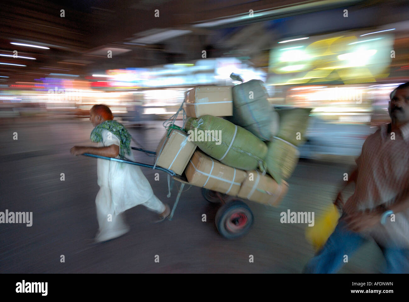 man dragging a fully loaded cart, Dubai City, United Arab Emirates ...