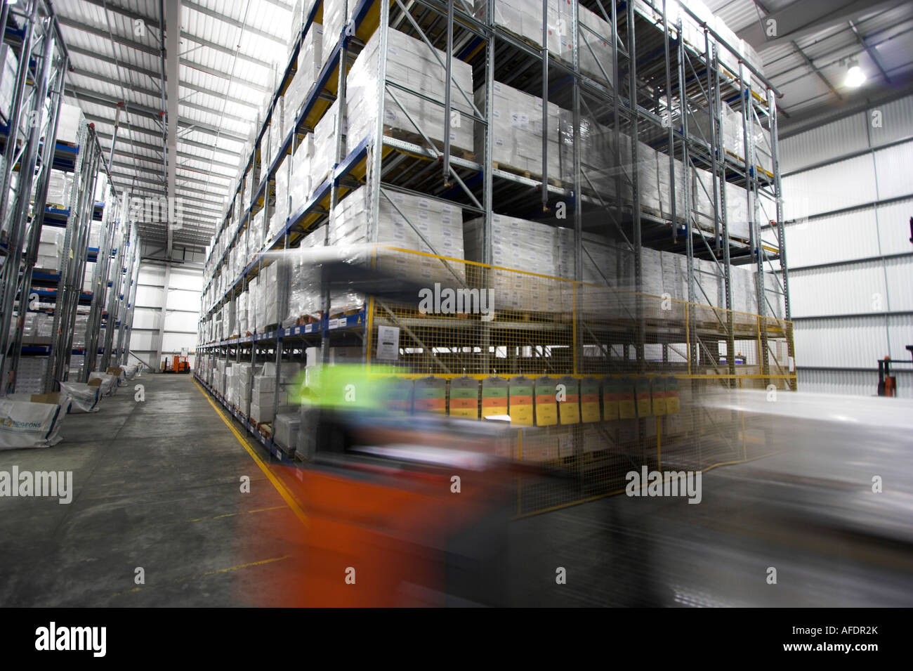 Fork truck moving in warehouse Stock Photo - Alamy