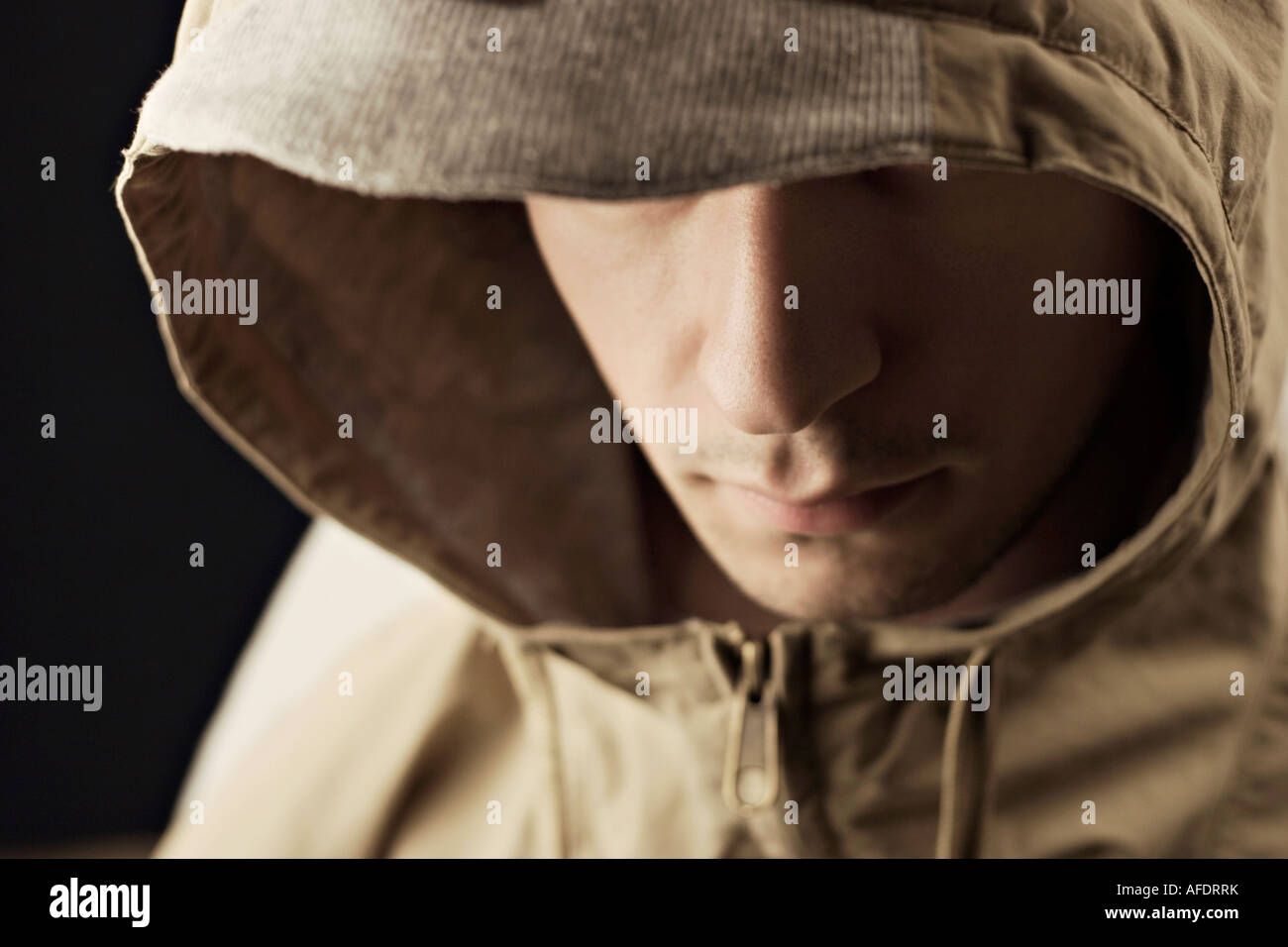 Young man wearing hood jacket, close-up Stock Photo - Alamy