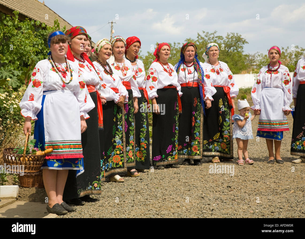 Countrywomen wearing traditional Ukrainian costumes are singing in ...