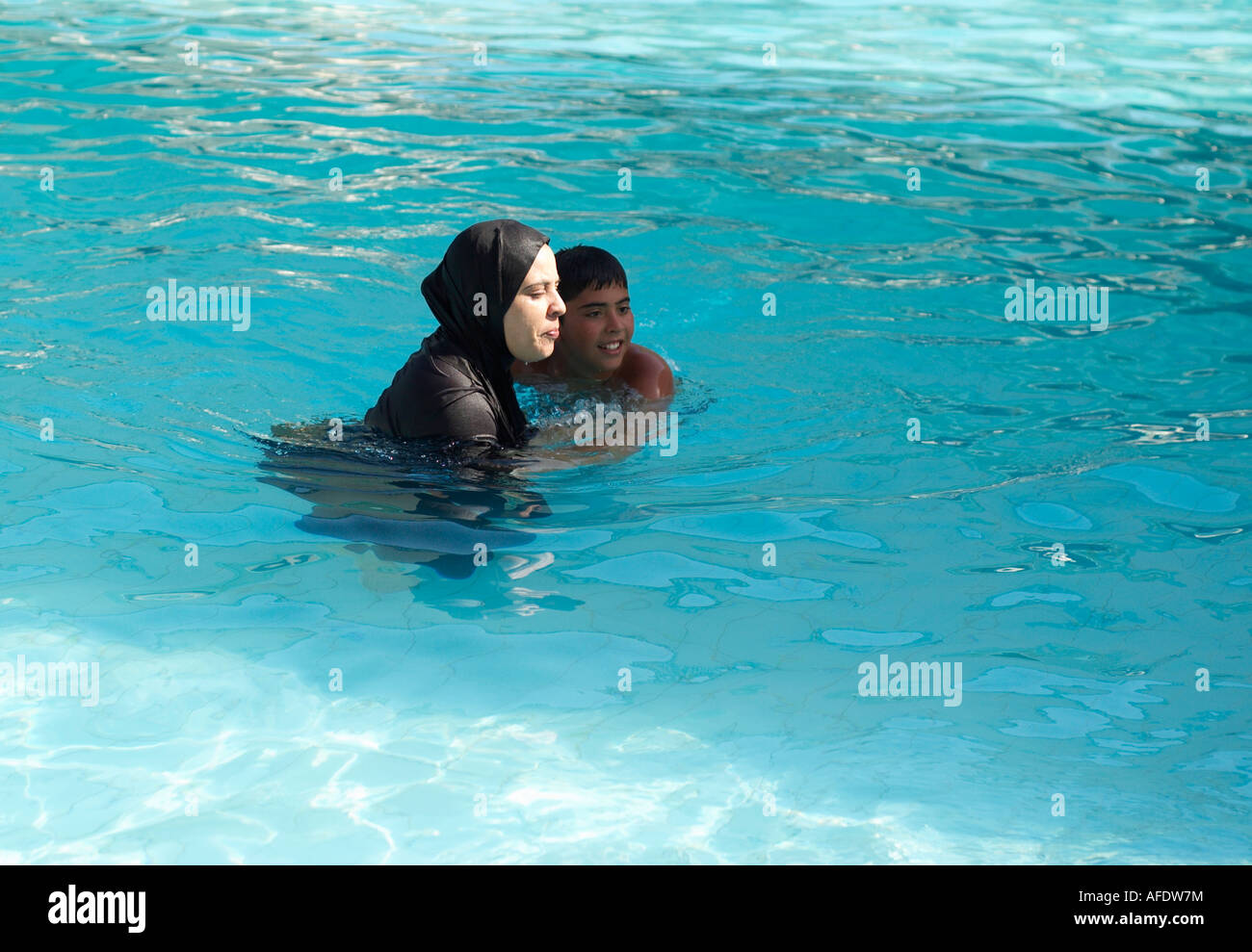 Arab mother with son swimming Stock Photo - Alamy