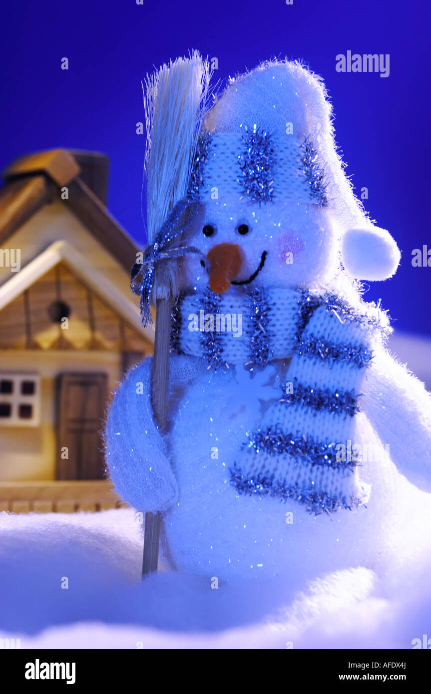 Christmas still life Snowman standing near a wooden house Snow winter ...