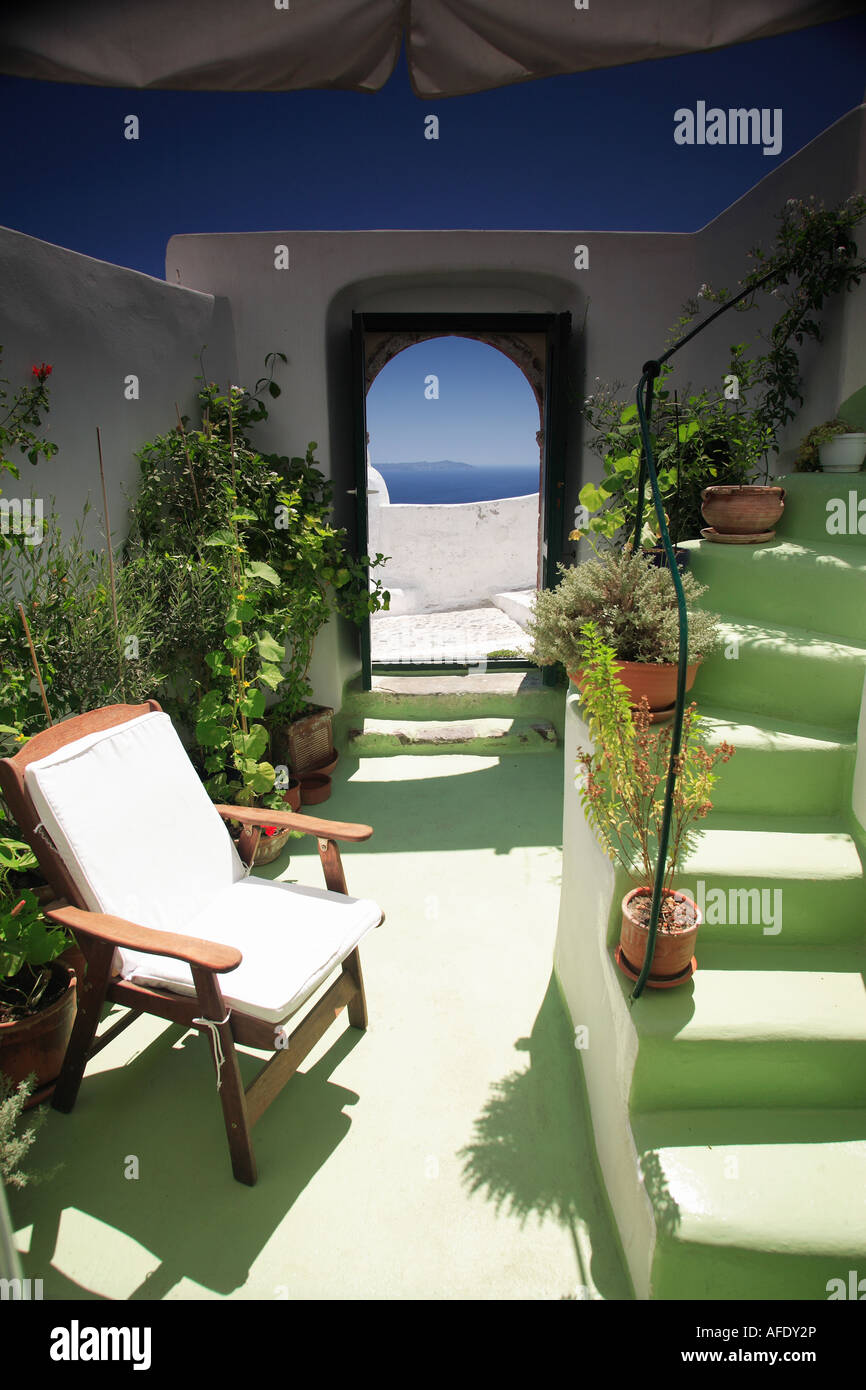 authentic greek courtyard with arched doorway, chair and staircase ...