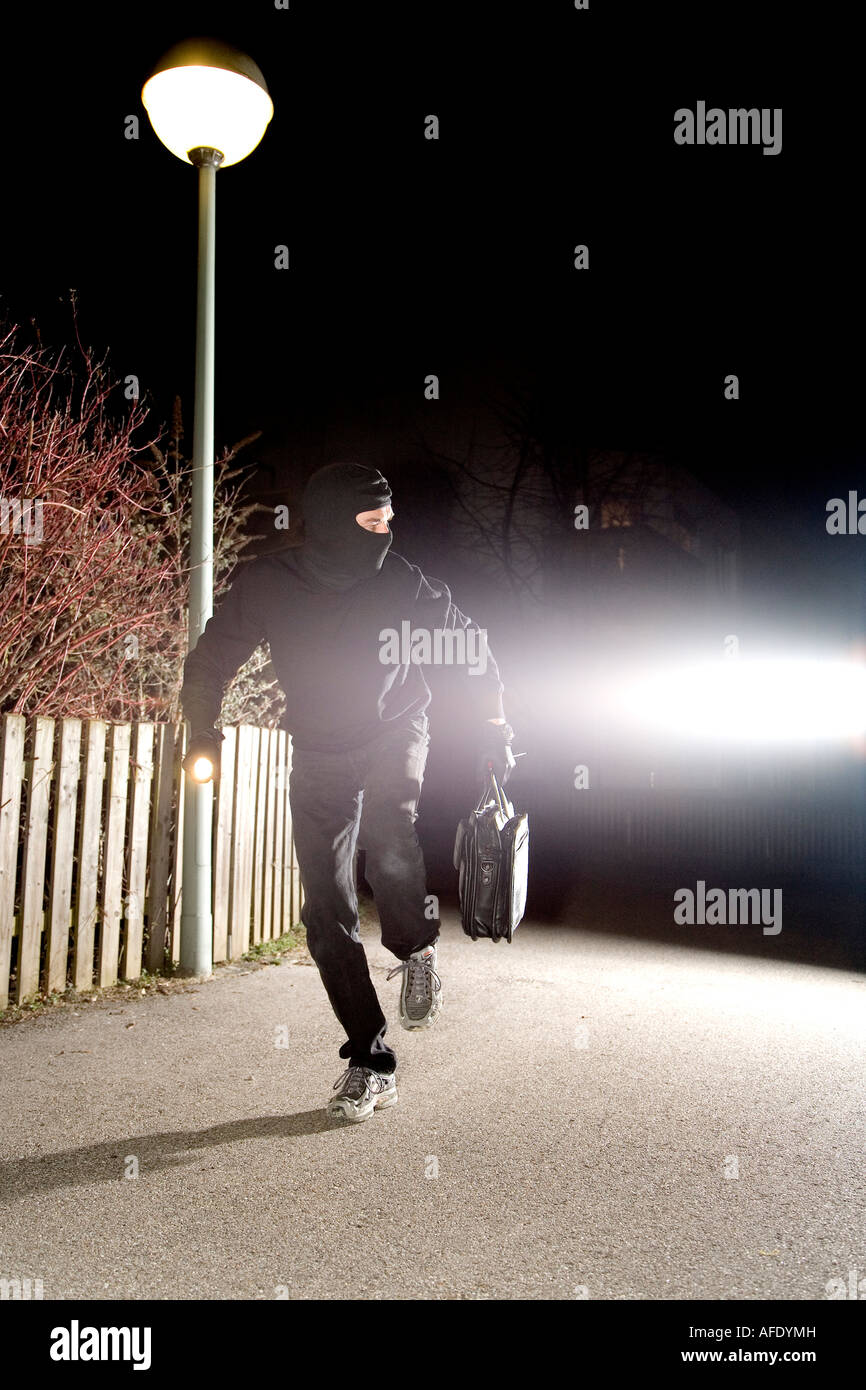 Burglar on the run Stock Photo - Alamy