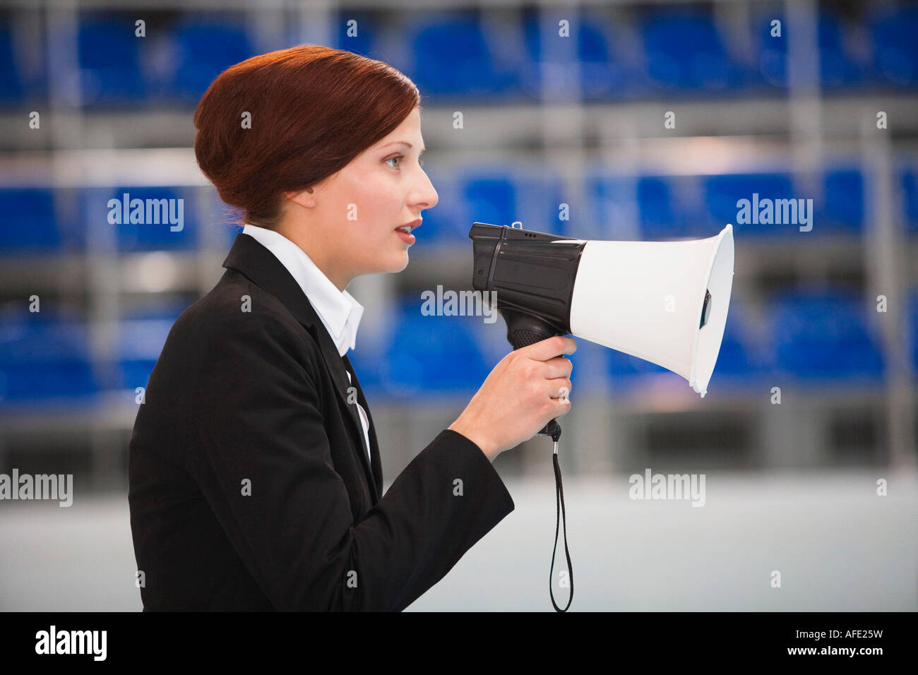 Young woman using megaphone Stock Photo - Alamy
