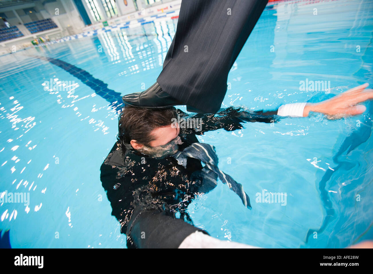 Businessman getting drowned Stock Photo - Alamy