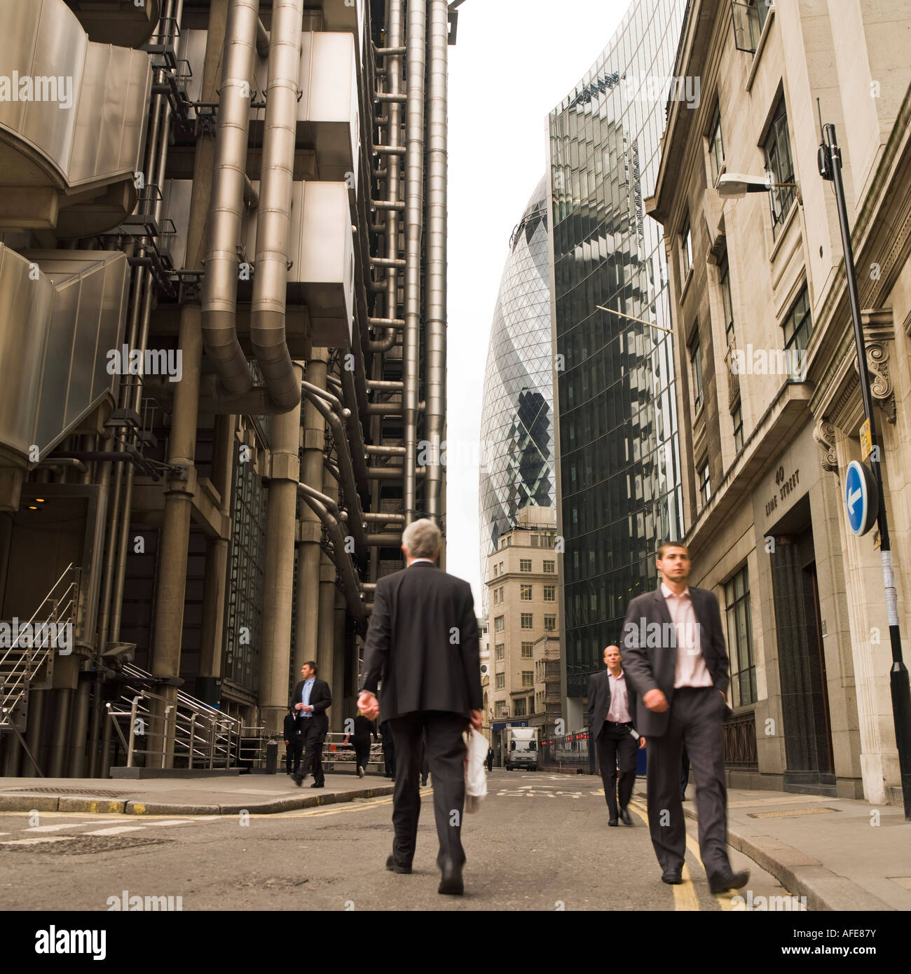 City workers businessman businessmen people walking past Lloyds London ...