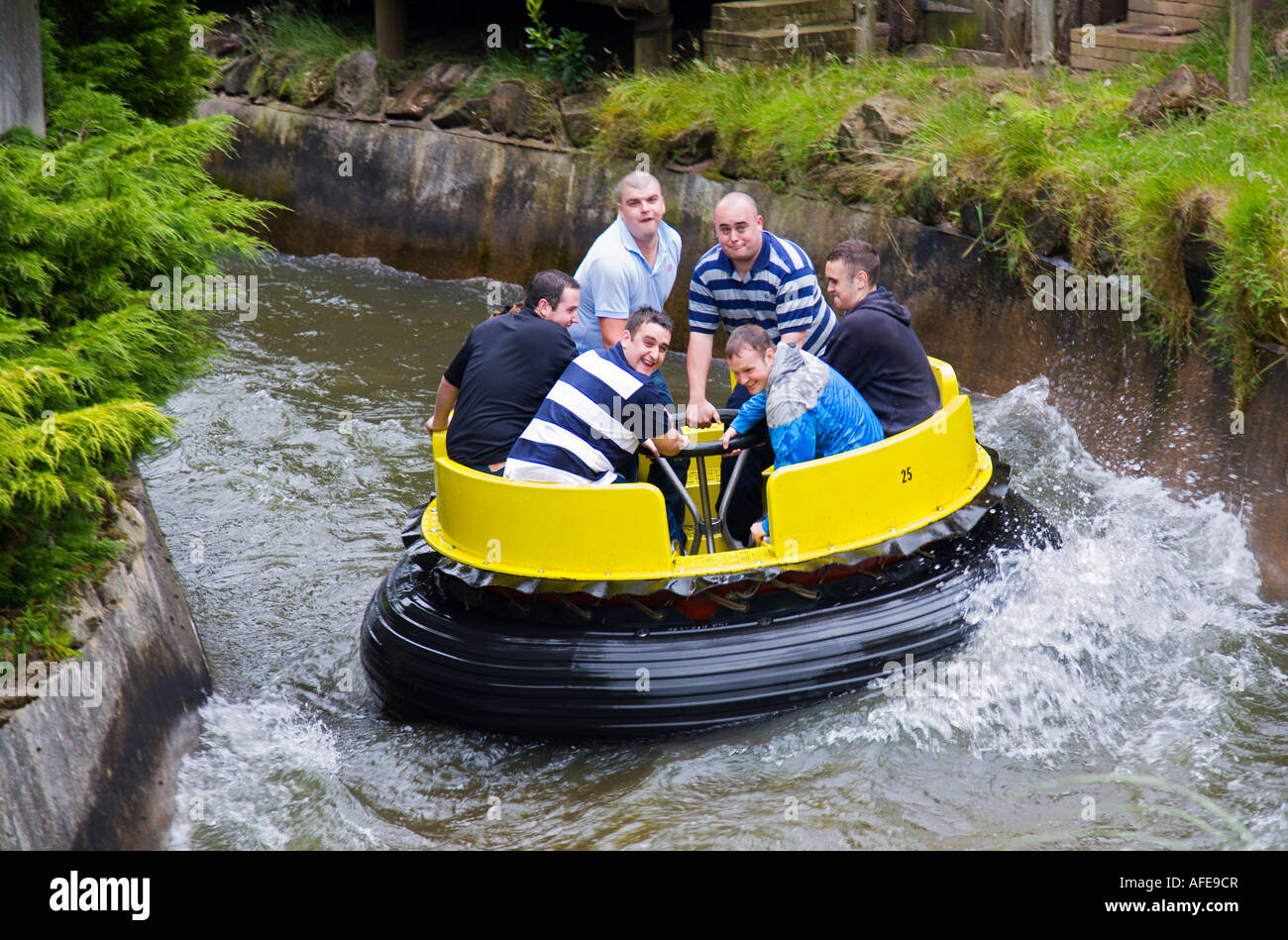 Group of young men on wild water rapids theme park ride Stock Photo - Alamy