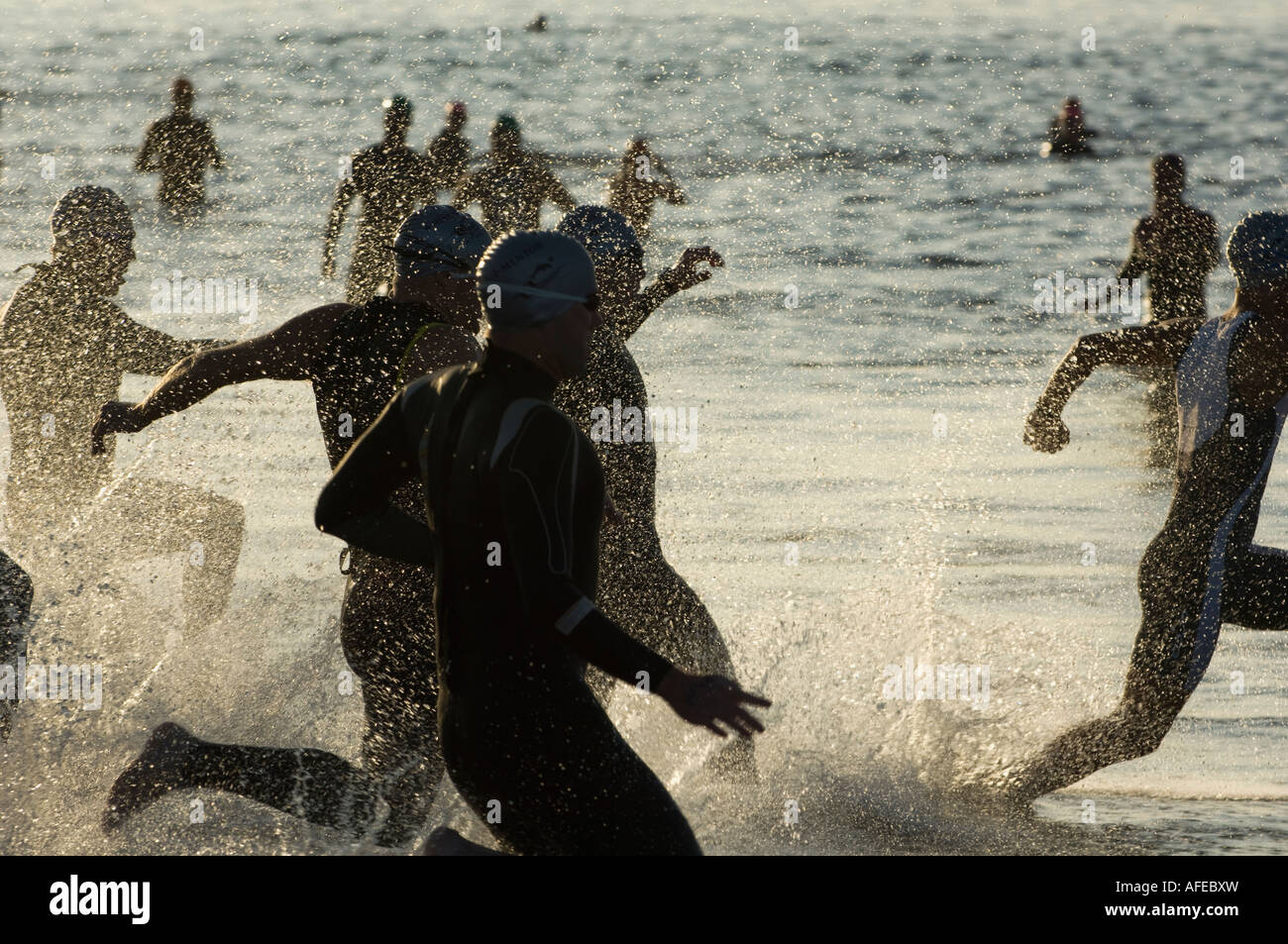 Swimmers run into cold Pacific ocean for swimming section of Santa ...