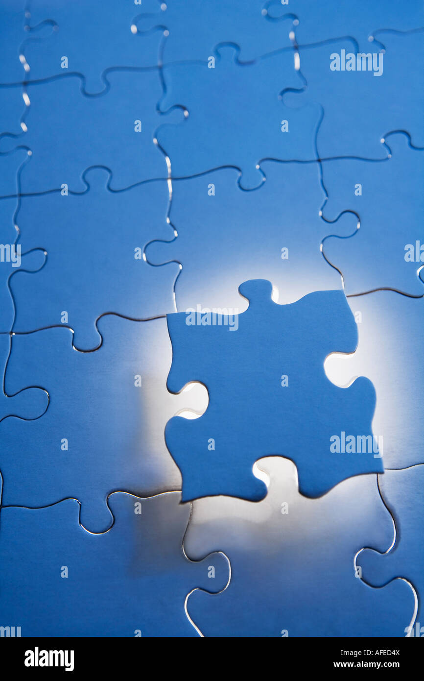 Puzzle piece fitting into puzzle Stock Photo - Alamy