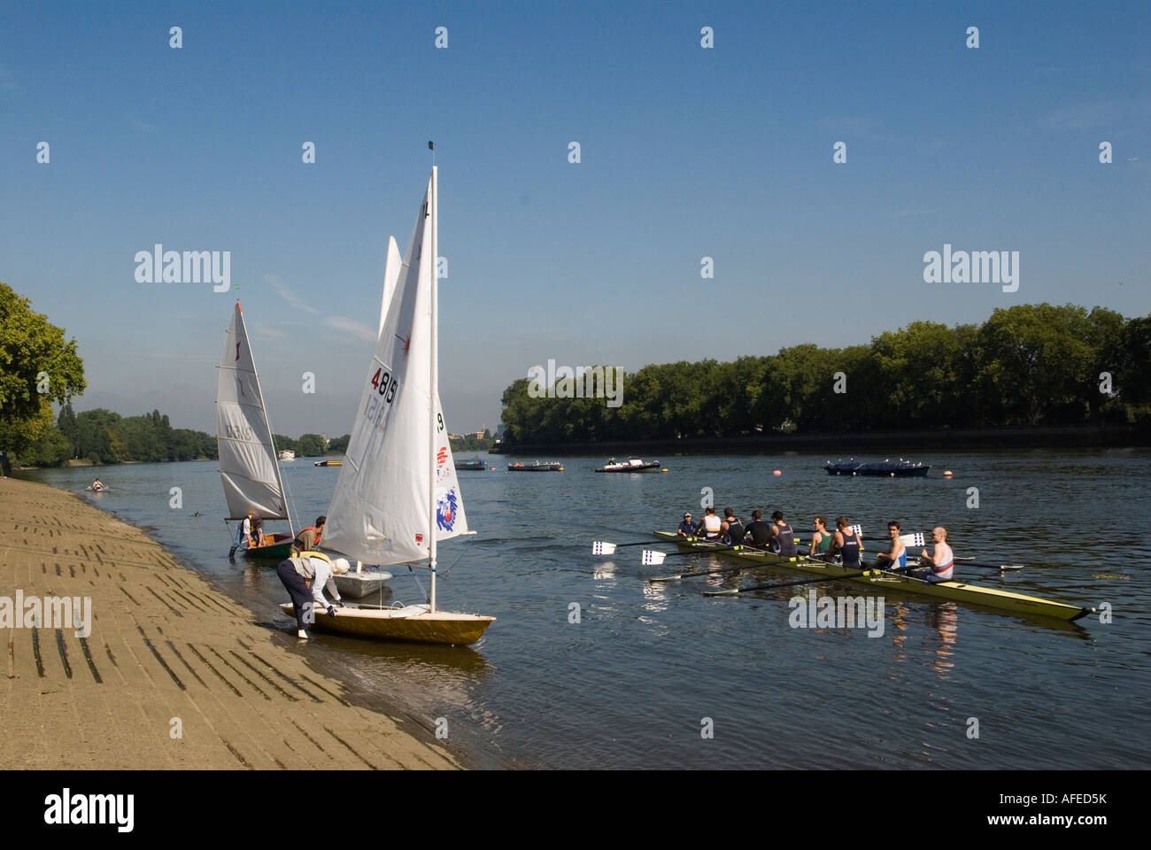 Dinghy sailing boats and rowing boats River Thames at Putney London ...