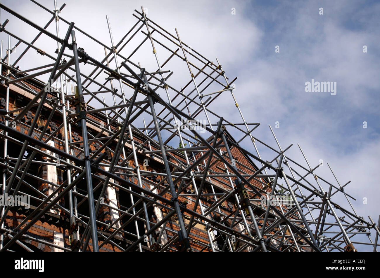 A VICTORIAN RED BRICK BUILDING SURROUNDED BY SCAFFOLDING MANCHESTER UK ...