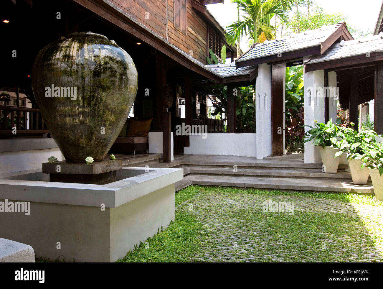 A large ceramic pot is the central decor focus of an Asian spa ...