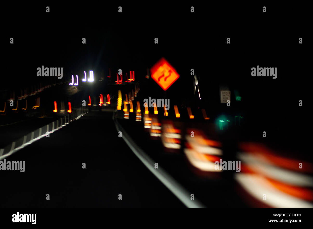 Traffic with construction barrels at night on a United States ...