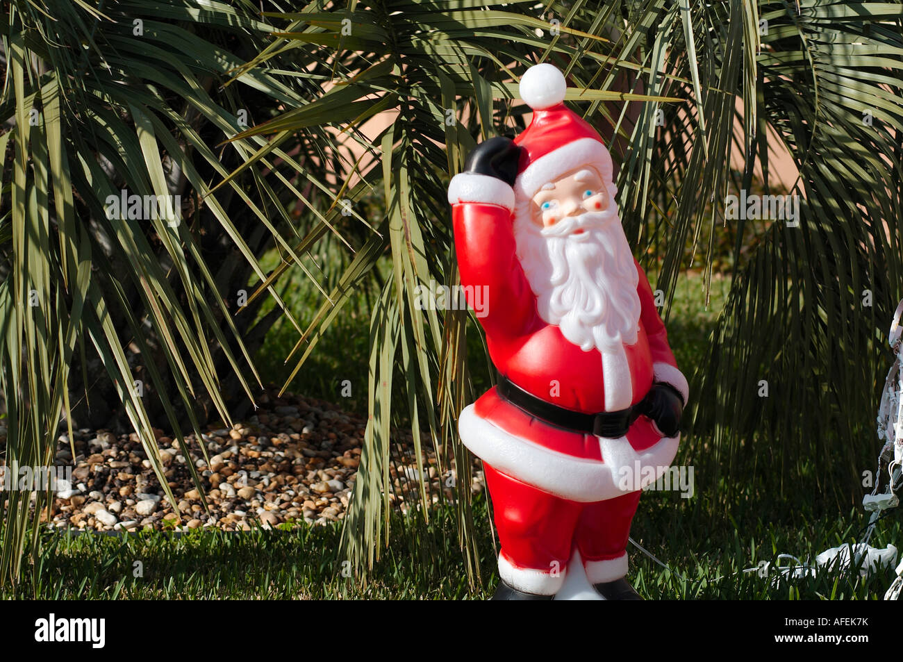 A Santa Claus figurine among palm fronds in Florida Stock Photo - Alamy