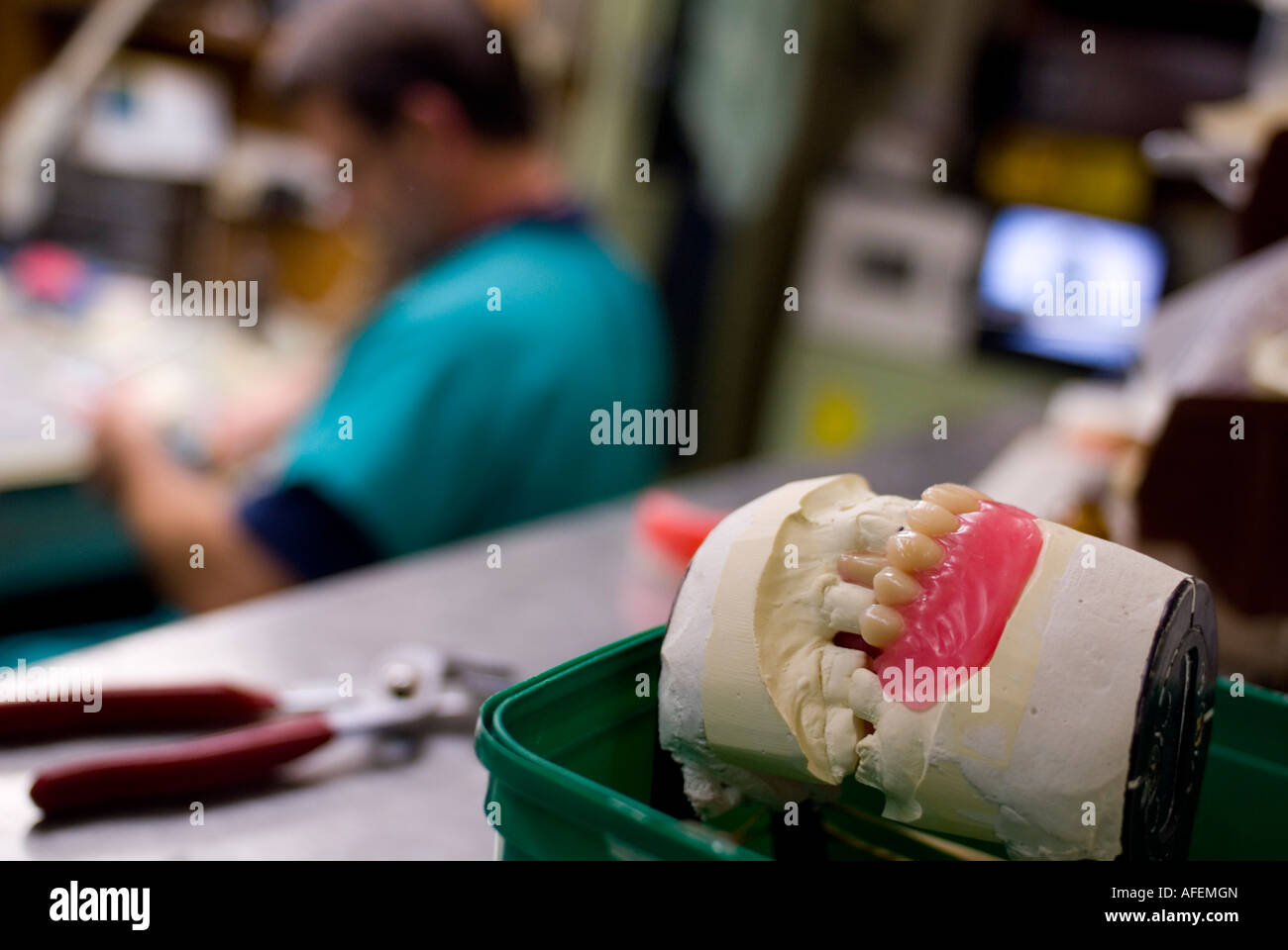 partial denture mould, dental prosthetist working in background Stock ...