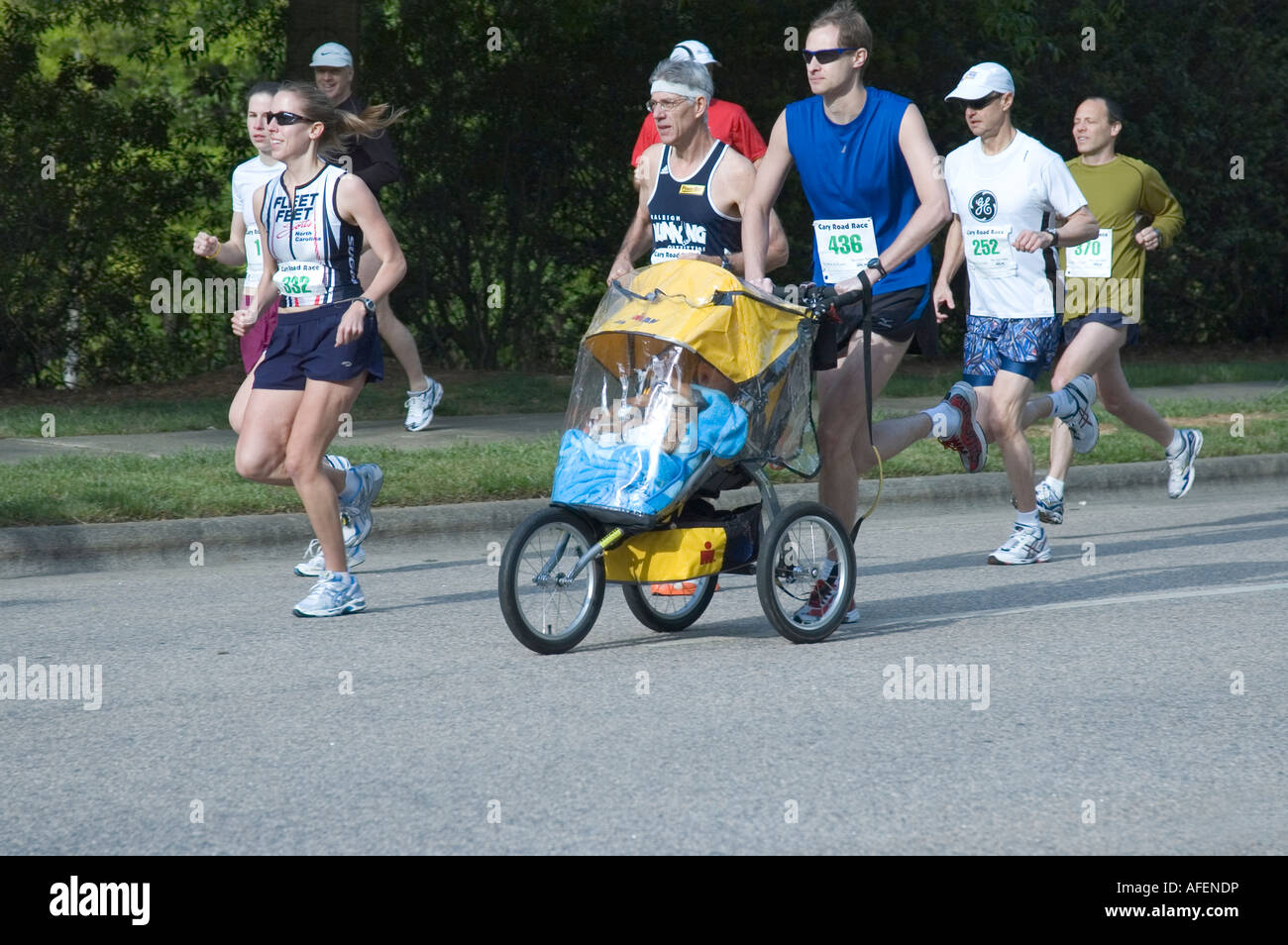 Man with baby in stroller running in a road race, Cary, North Carolina ...