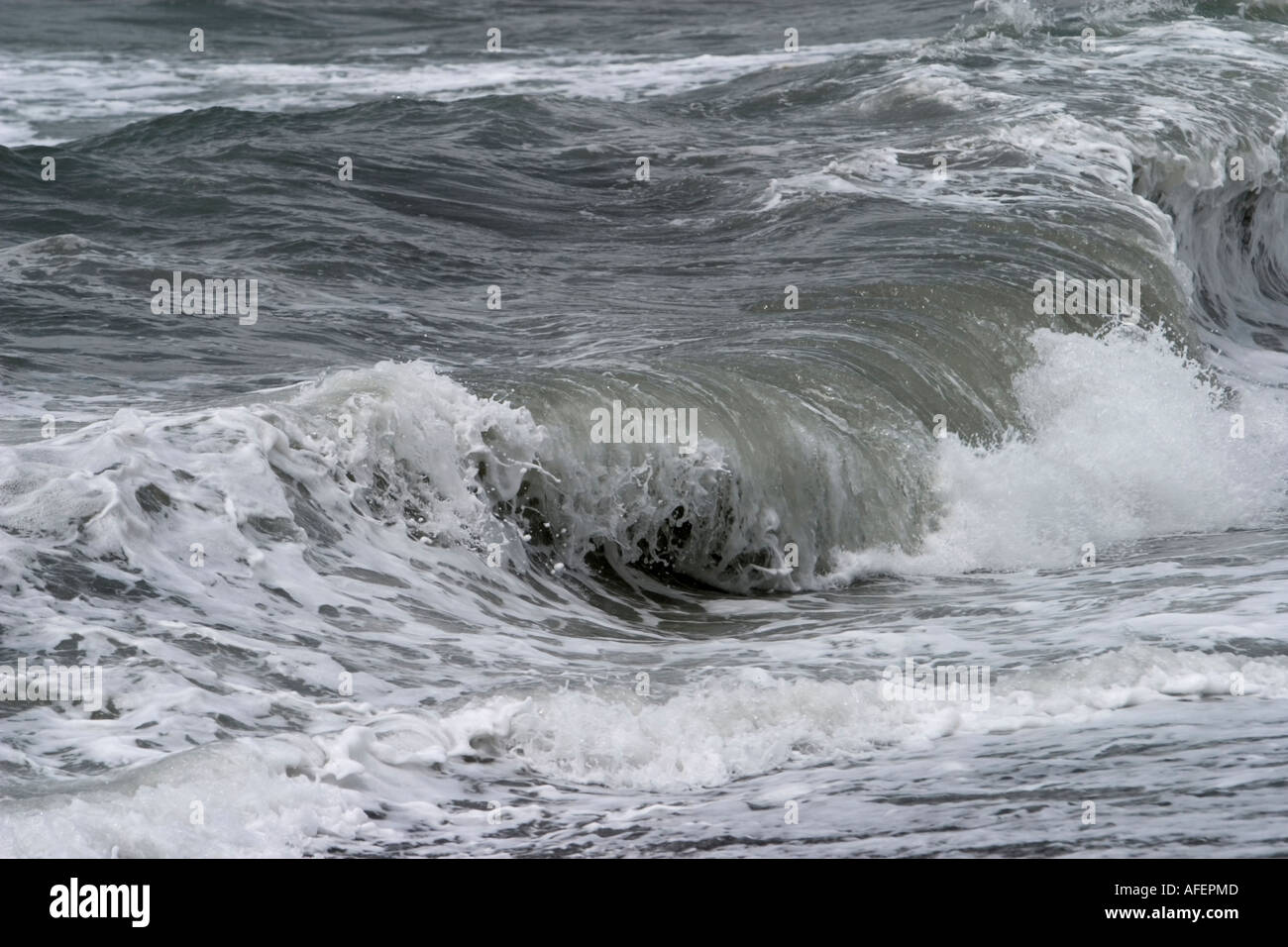 Waves crashing onto a beach Stock Photo - Alamy
