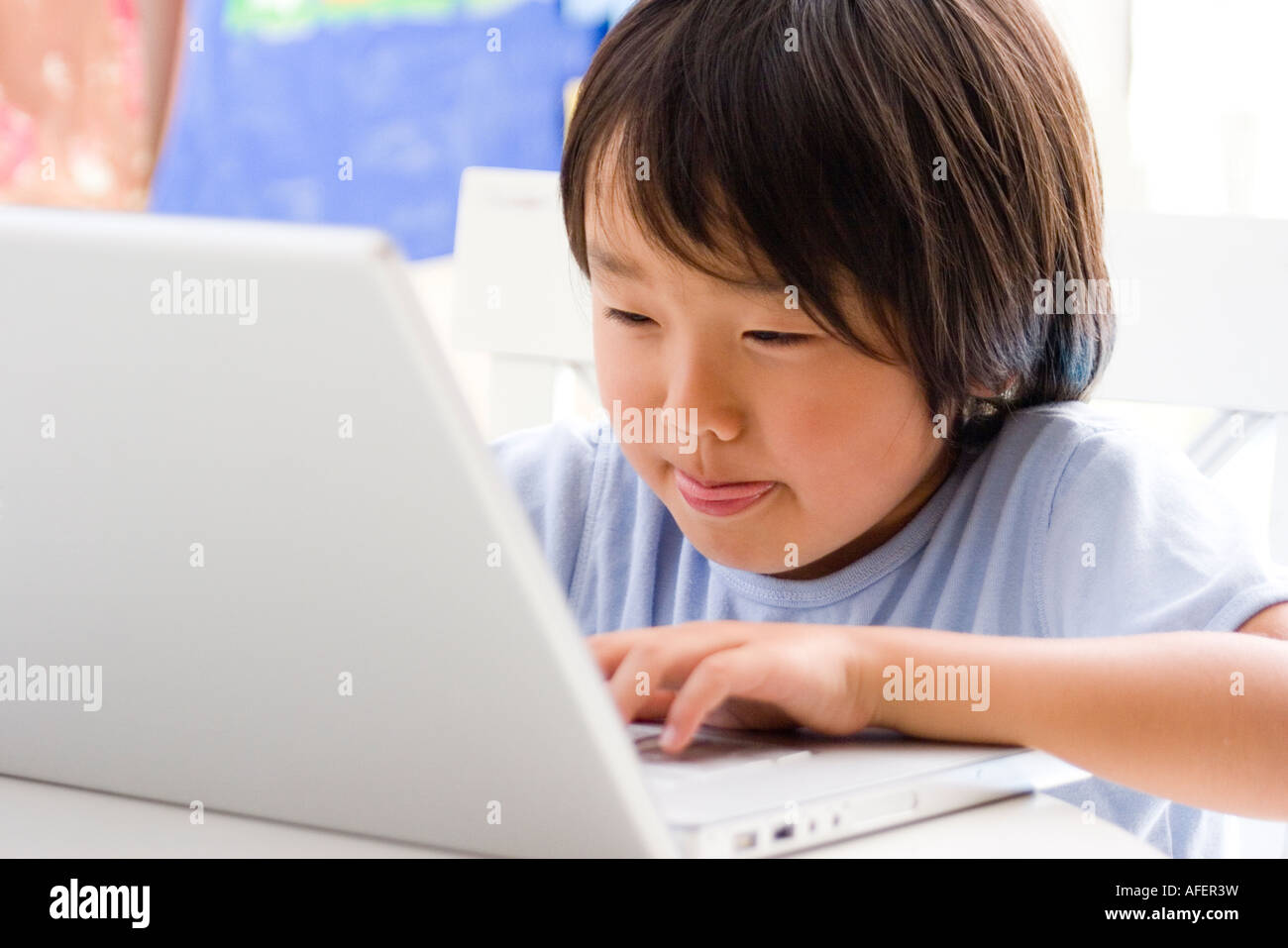 Young Boy Playing a Game on a Laptop Computer Stock Photo - Alamy