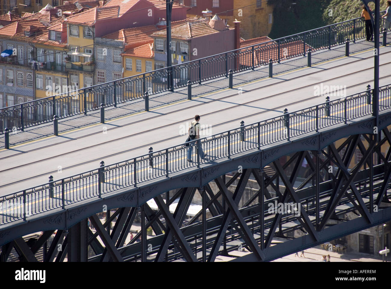 Walking person crossing a bridge in Porto, Portugal Stock Photo - Alamy