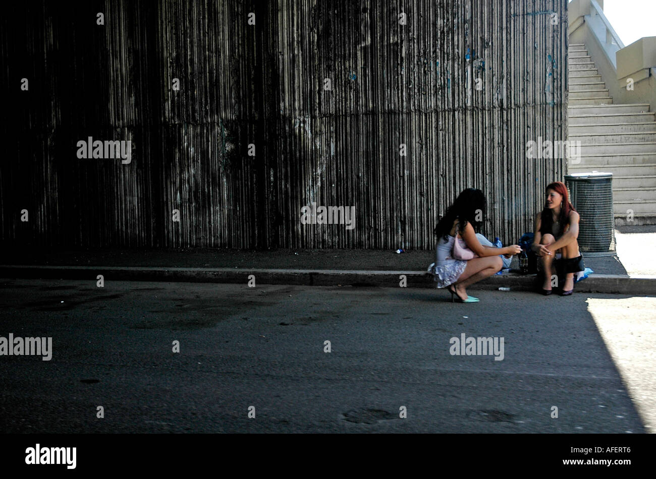 Prostitutes crouching and waiting for customers in a tunnel entrance ...