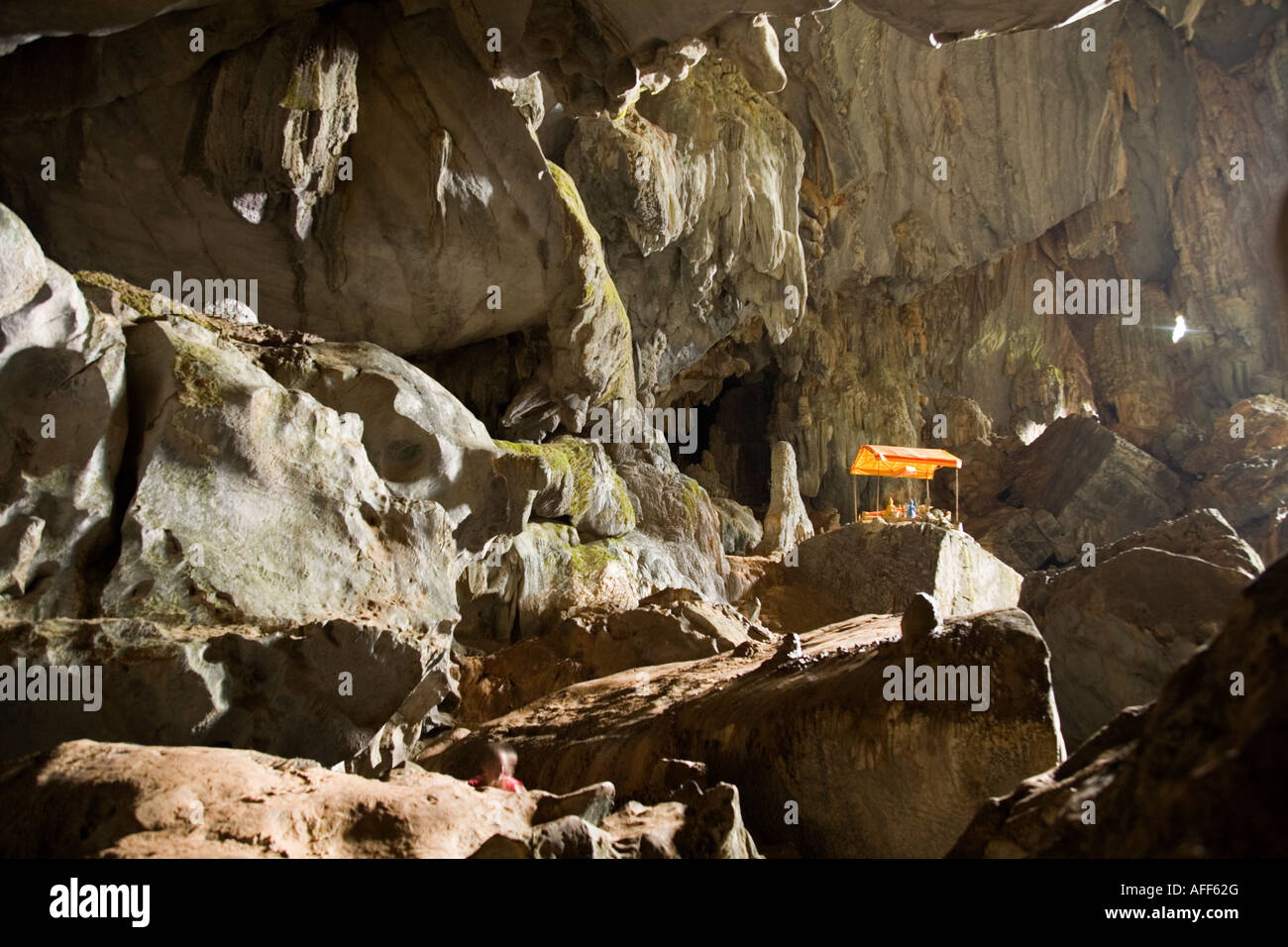 Large gallery with reclining buddha shrine in the Tham Phu Kham ...