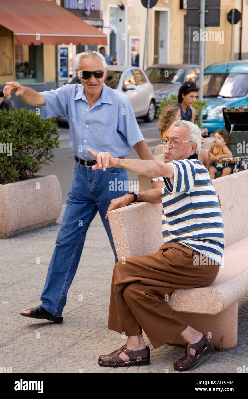Old man giving directions to another old man in Porto Santo Stefano ...