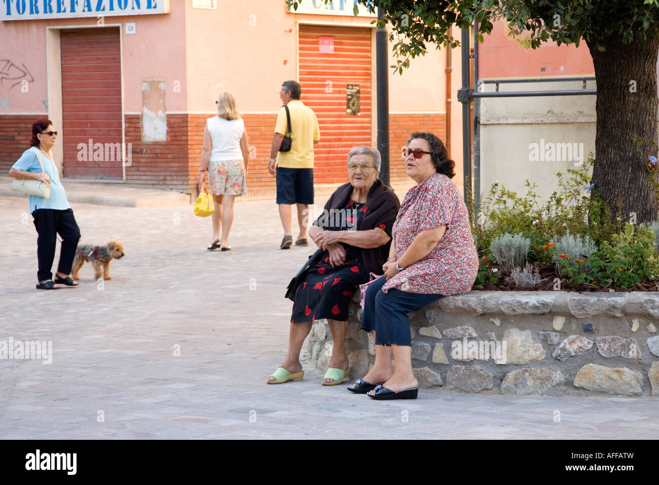 Old ladies sitting under a tree in Porto Santo Stefano Monte Argentario ...