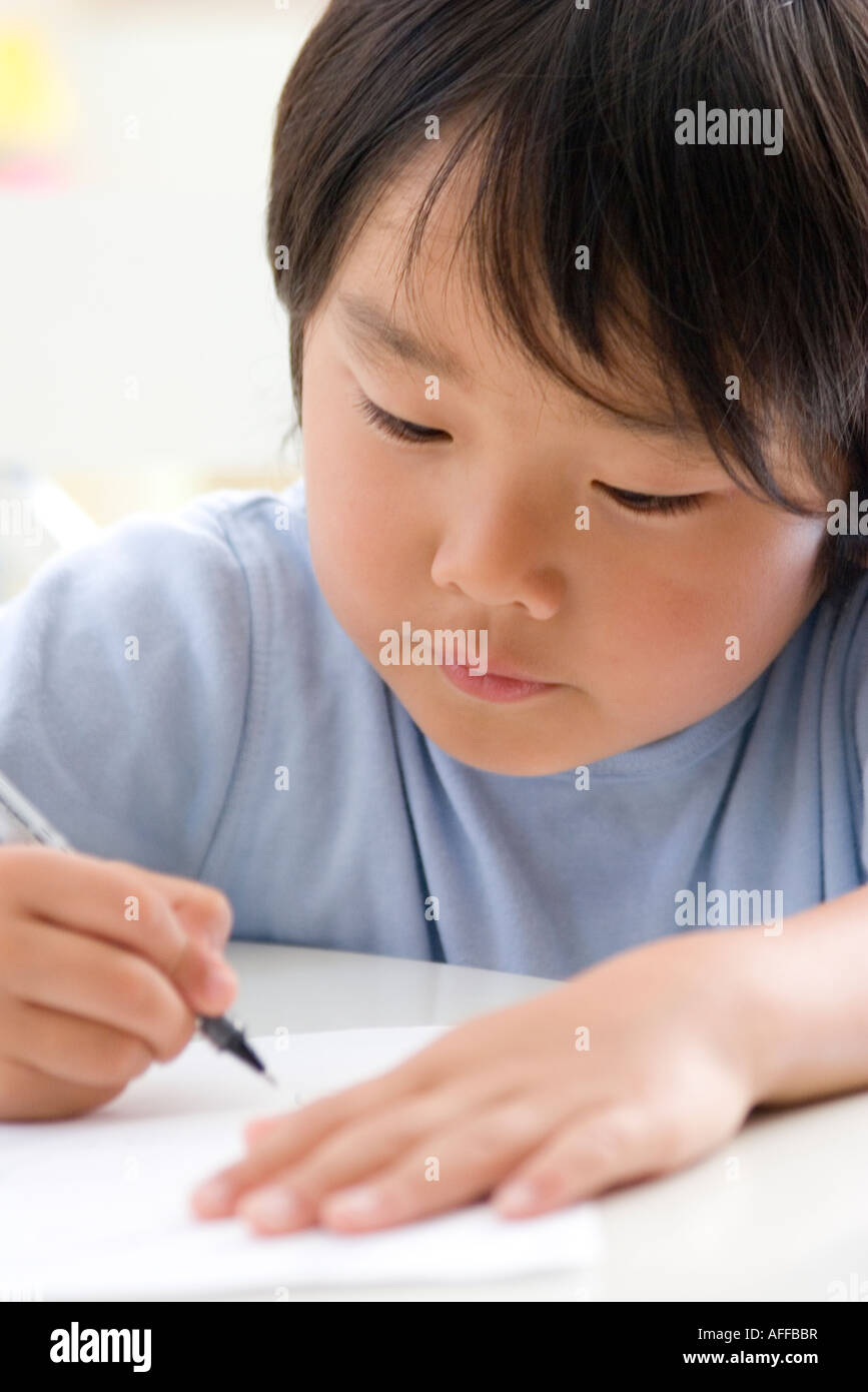 Young Boy Writing Stock Photo - Alamy
